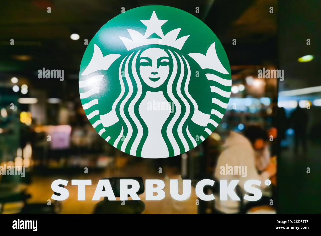 Starbucks logo is seen on a coffee shop at the railway station in ...