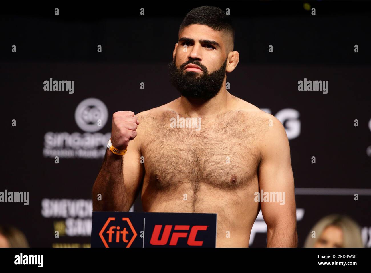 Jacob Malkoun of Australia reacts on the scale during the UFC 275 Weigh ...