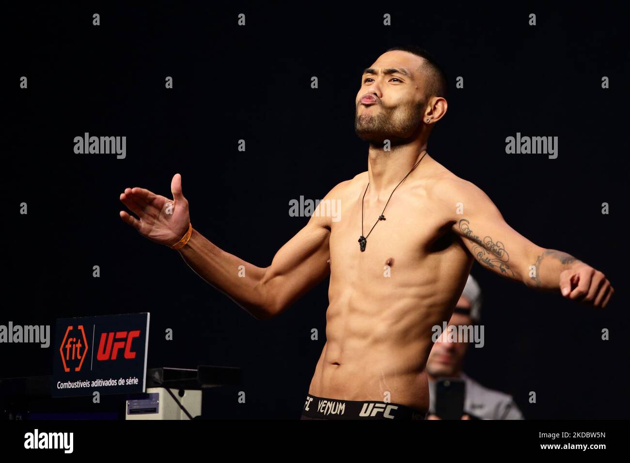 Josh Culibao of Australia reacts on the scale during the UFC 275 Weigh ...