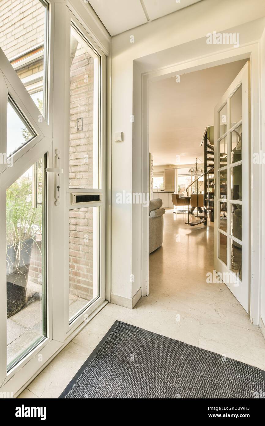 Light narrow hallway with many doors in white walls and glowing lamp ...