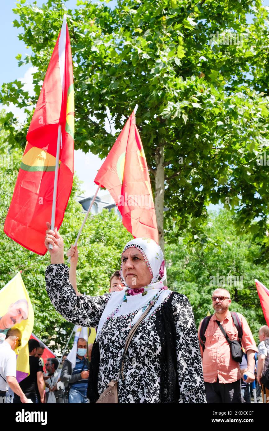 A Kurdish mother holding a PKK flag demonstrates to denounce Turkey's ...