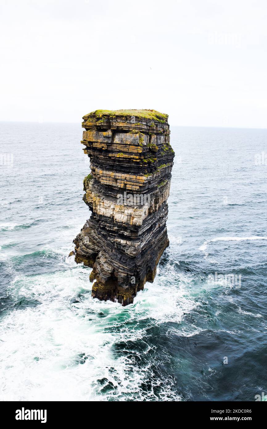 A vertical shot of the Downpatrick Head peninsula stone formation in ...