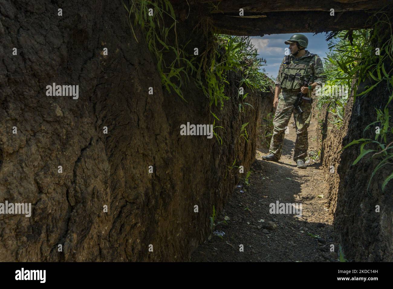 A ukrainian soldier inside a trench in the frontline of the ...
