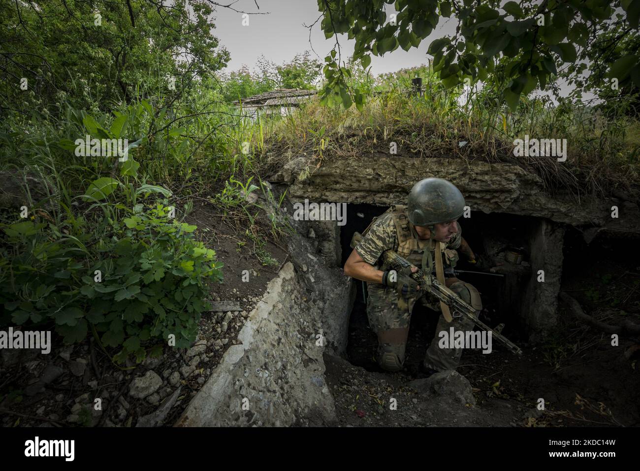 A ukrainian soldier covers himself in his bunker during the shellings ...