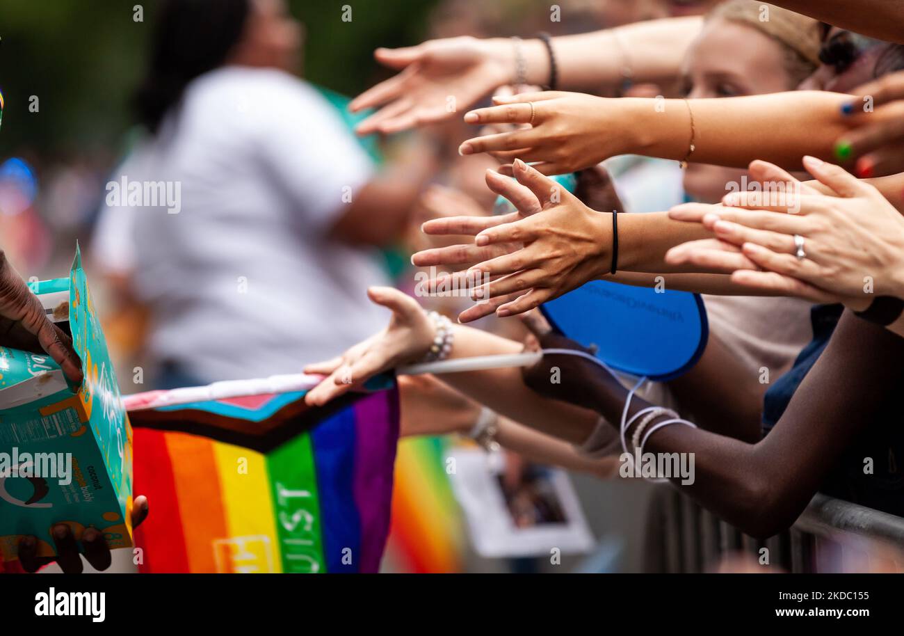 Spectators at Washington, DC’s annual Pride Parade reach for party ...