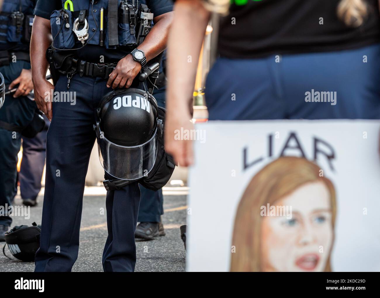 A Metropolitan Police (DC police) officer stands behind peaceful ...