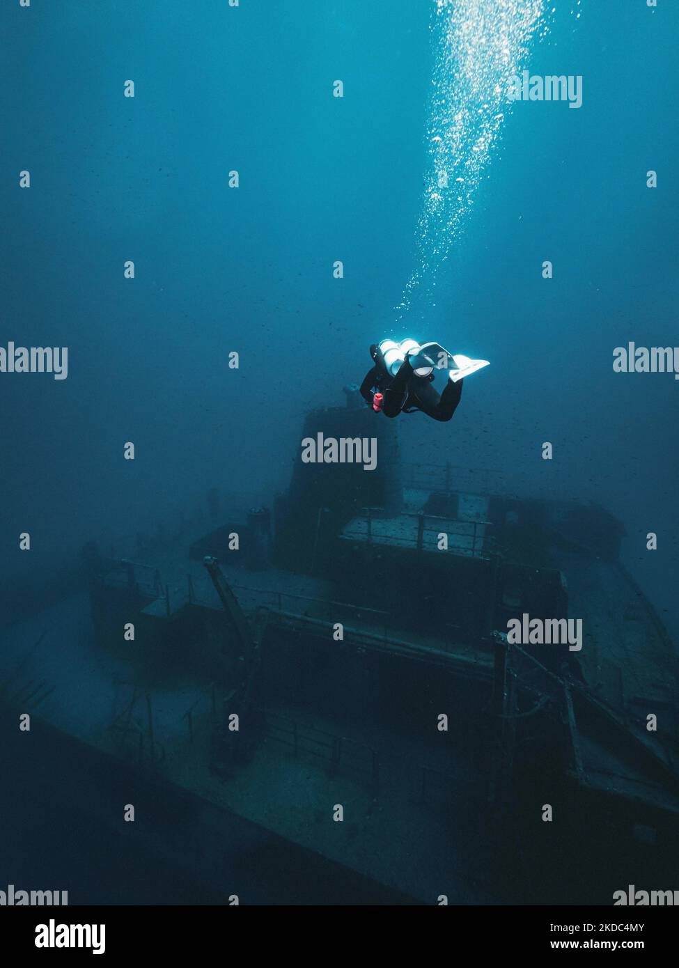 A scuba diver exploring a wrecked ship in the area of Gozo island ...