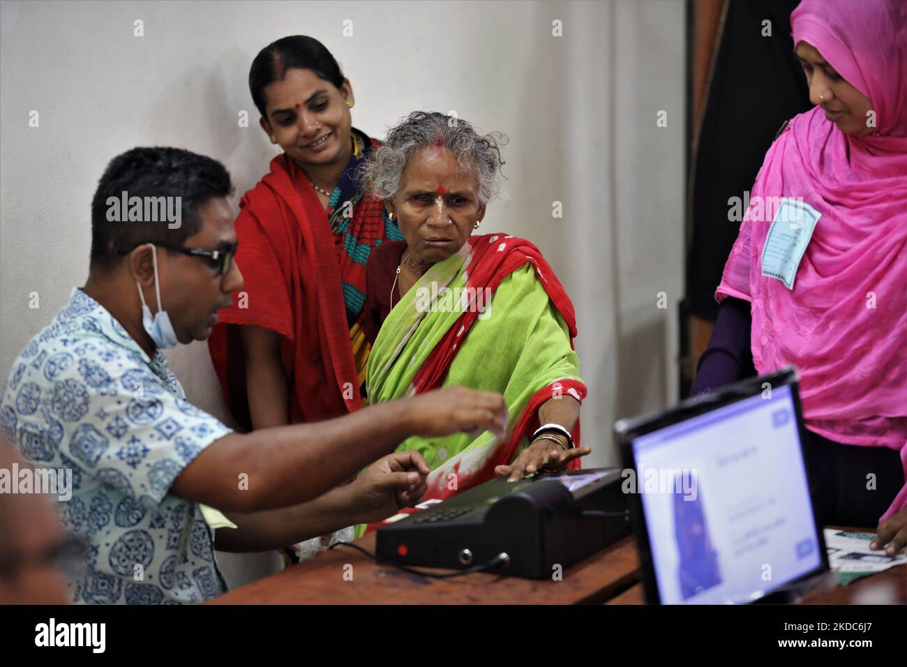 A Polling agent checks voter identity during Comilla city corporation ...