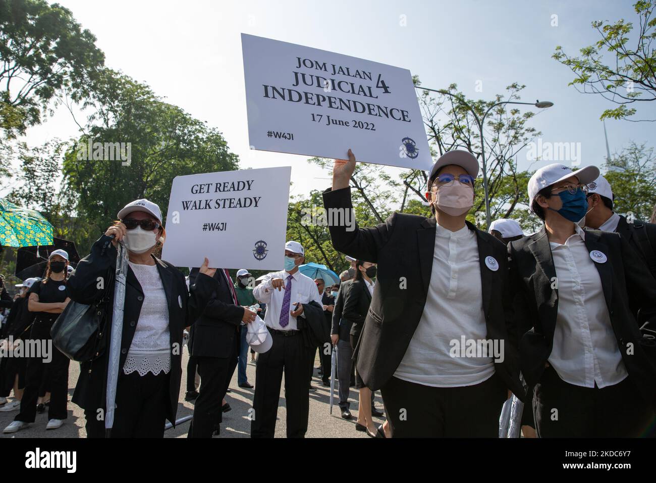 Lawyers holding placards in Padang Merbok, Kuala Lumpur during the Walk for Judicial ...