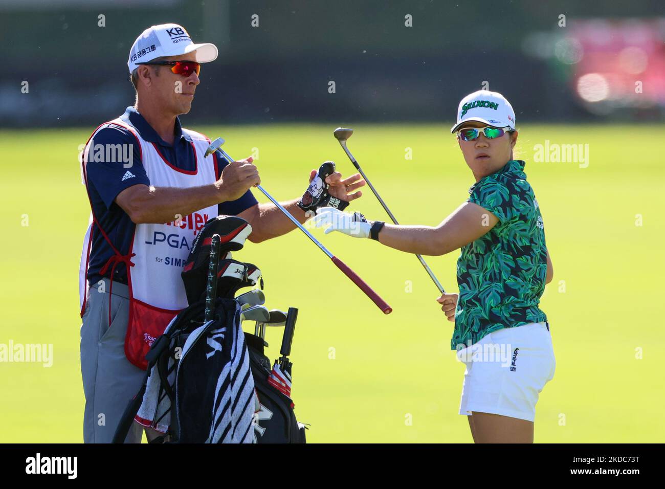 Nasa Hatoaka of Ibaraki, Japan is handed her putter by her caddie after ...