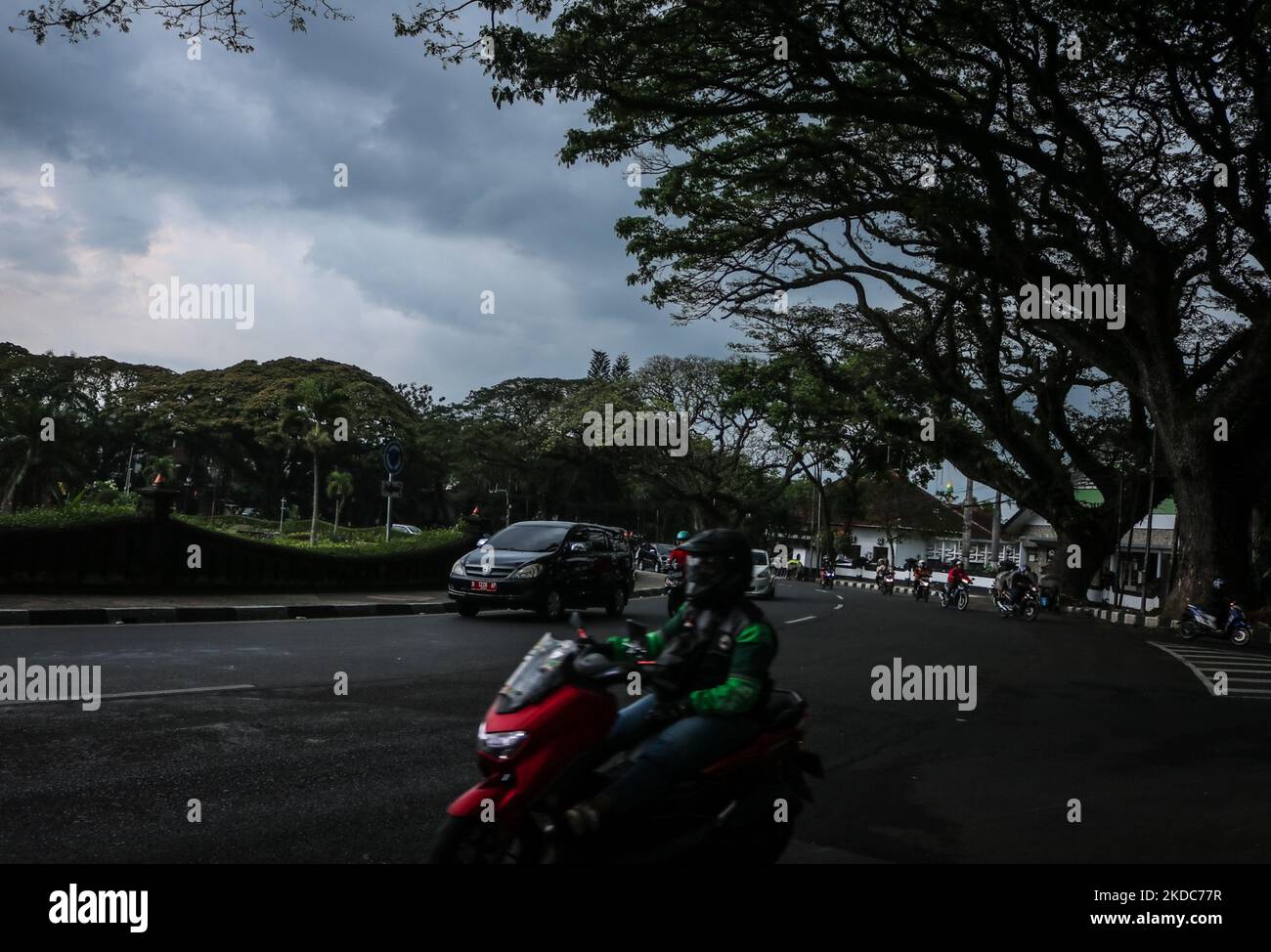 Residents pass by when the weather is cloudy in the square of Malang ...