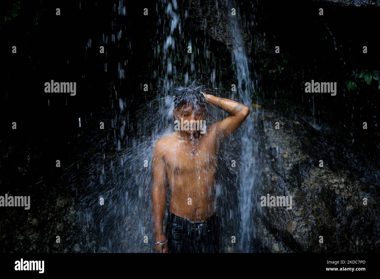 Nepali people have fun in waterfall to beat the heat at Jhor in ...