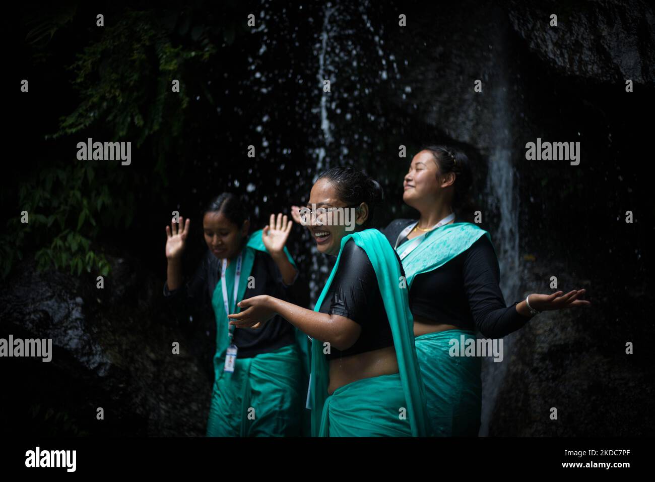 A woman enjoys a waterfall during monsoon at Jhor on the outskirts of ...