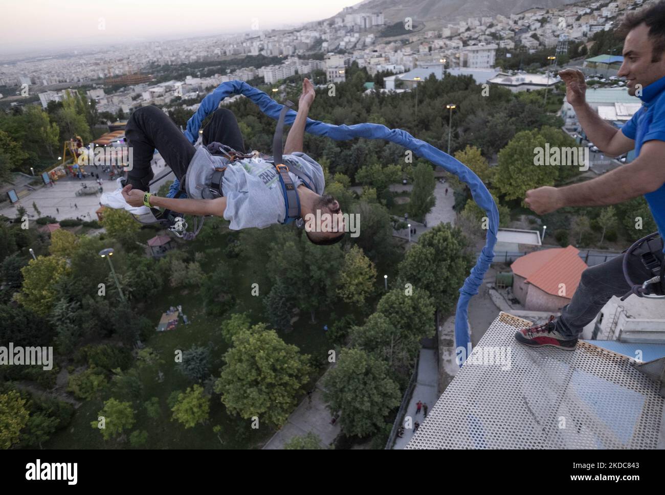 An Iranian bungee man makes a bungee jump from a 40-meter rig during ...