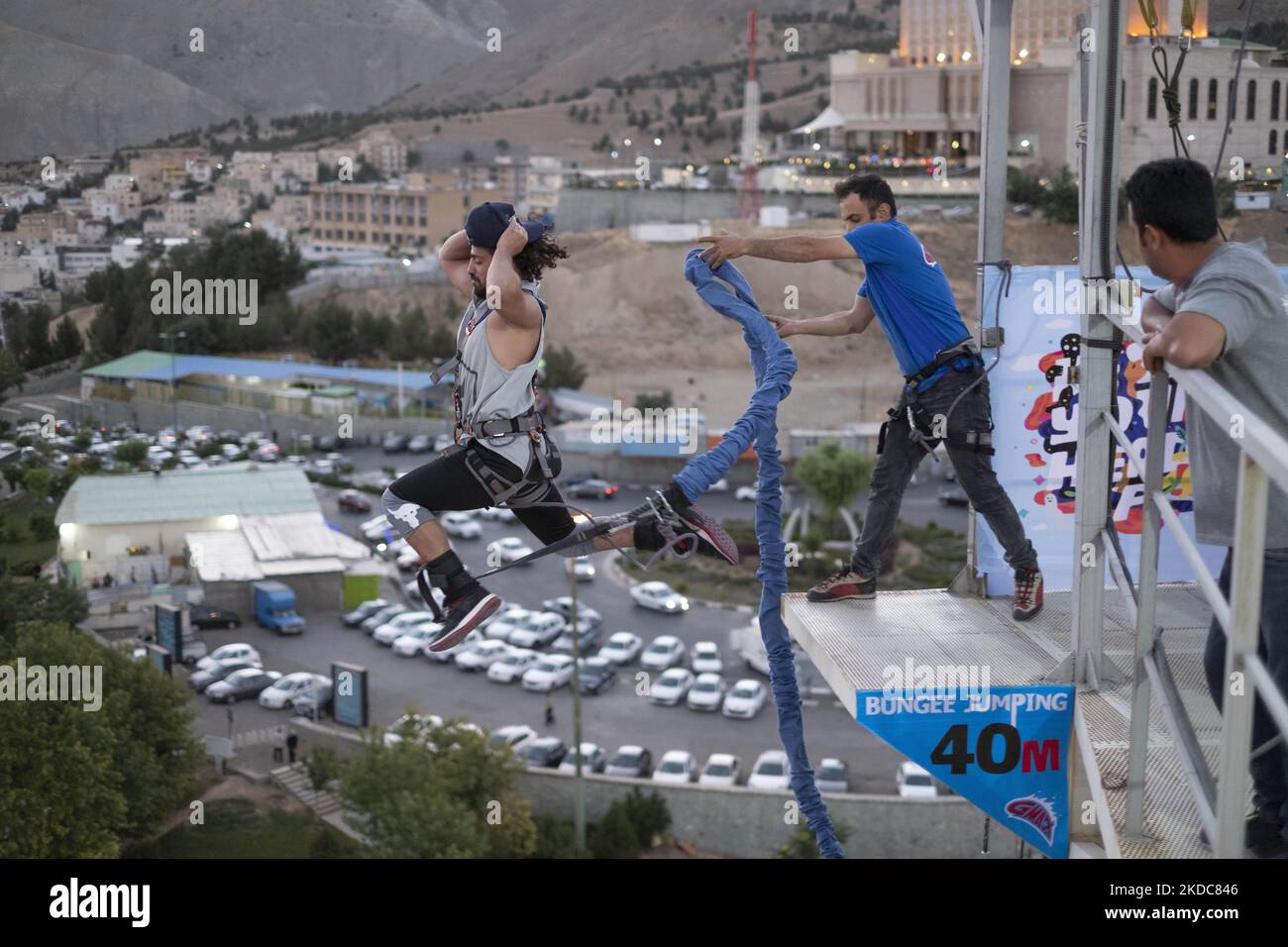 An Iranian bungee man makes a bungee jump from a 40-meter rig during ...