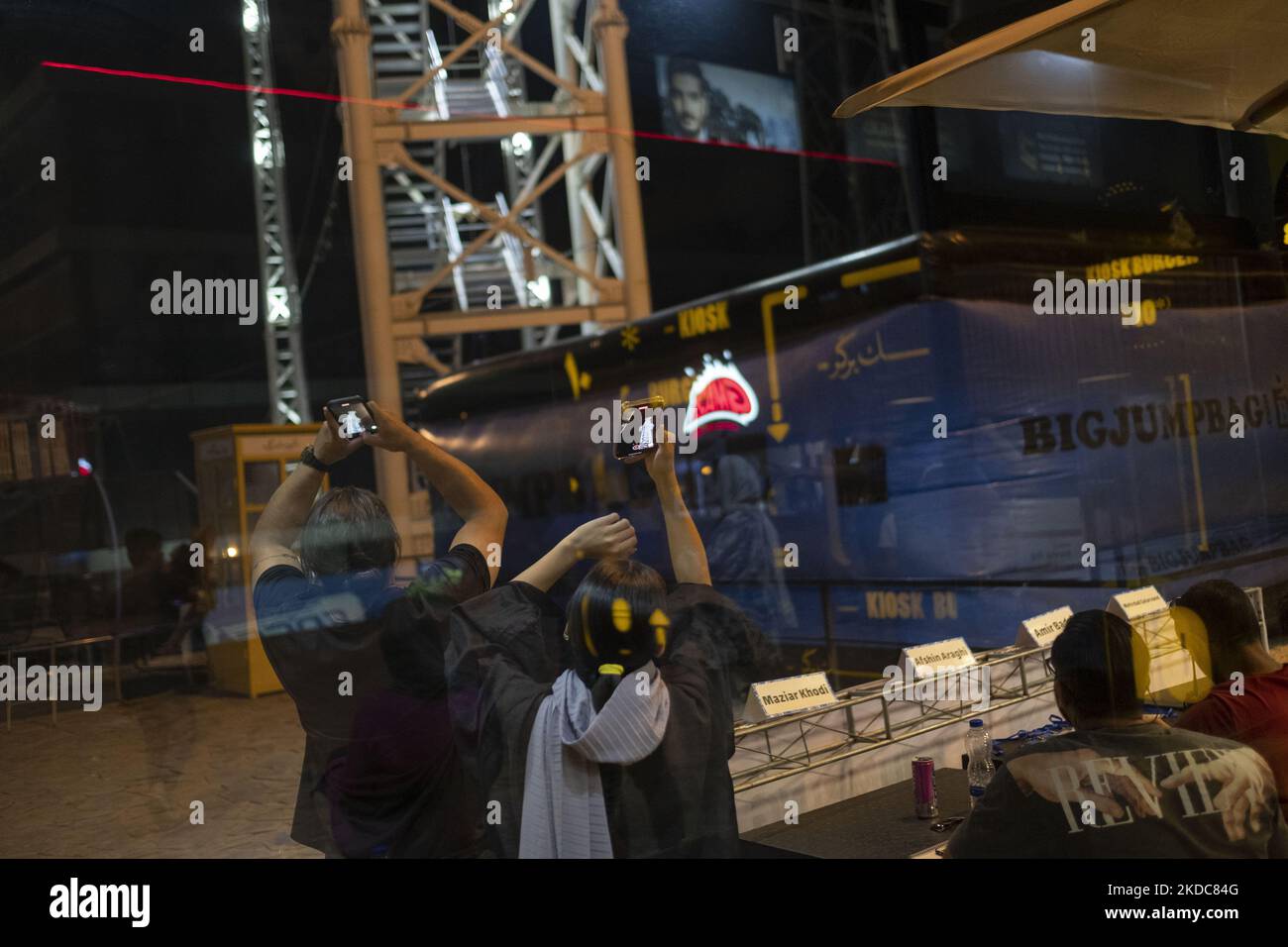 Iranian young people take videos of a bungee man performs a bungee ...