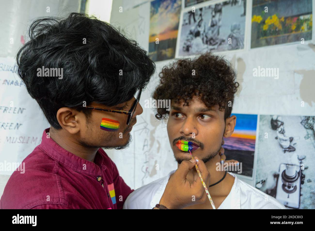 Participants are seen drawing rainbow colors on each others face during ...