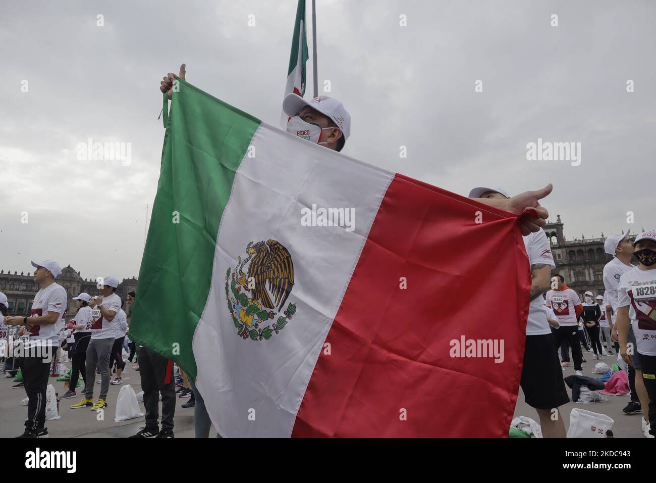 A person extends the Mexican flag during a massive boxing class in ...