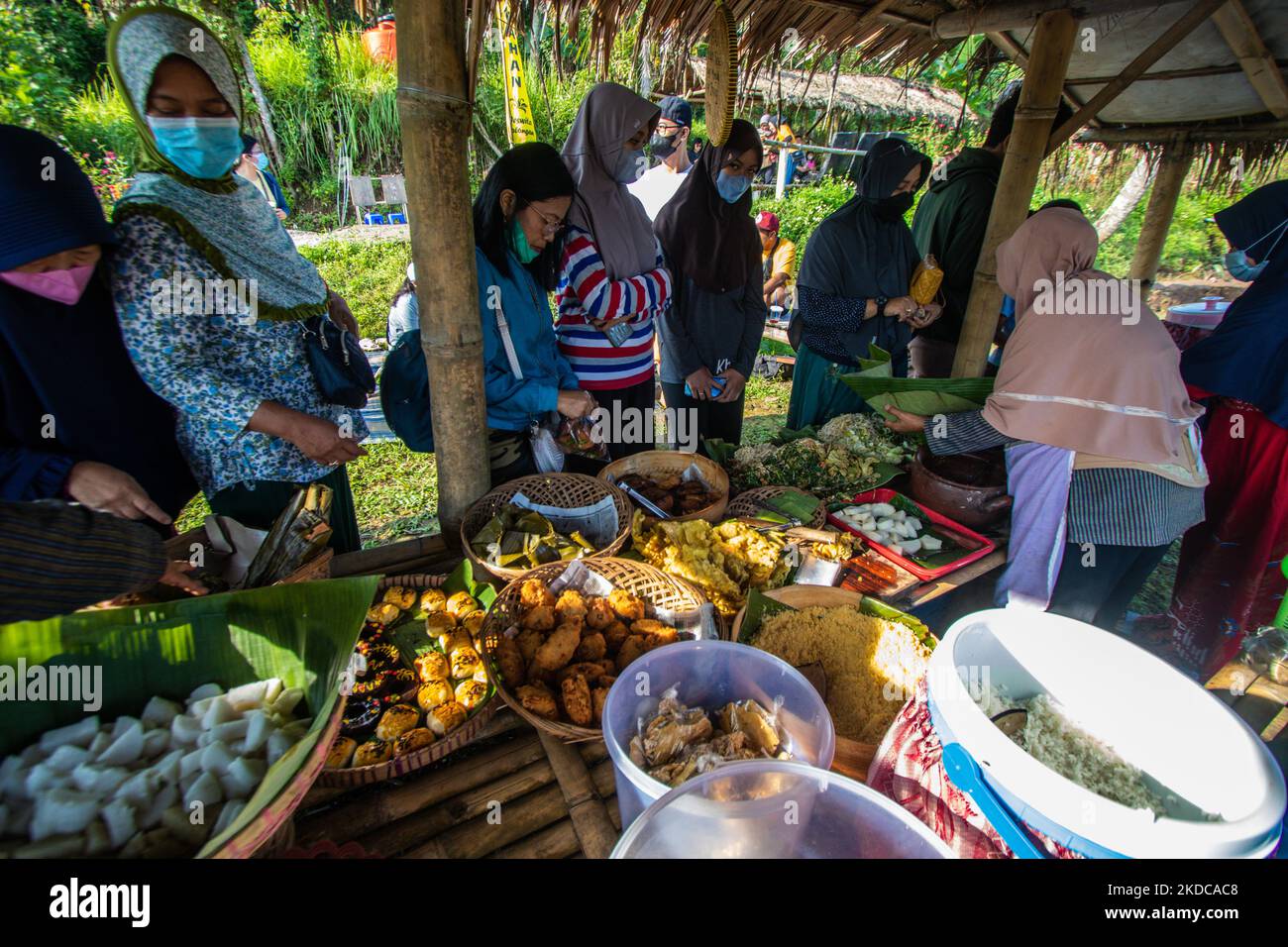 Tourists visit the Sawahan Market, a traditional snack market in ...