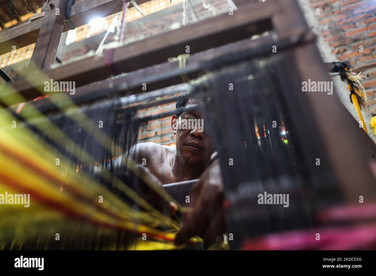 A worker weaver making textiles at the traditional weaving workshop at ...
