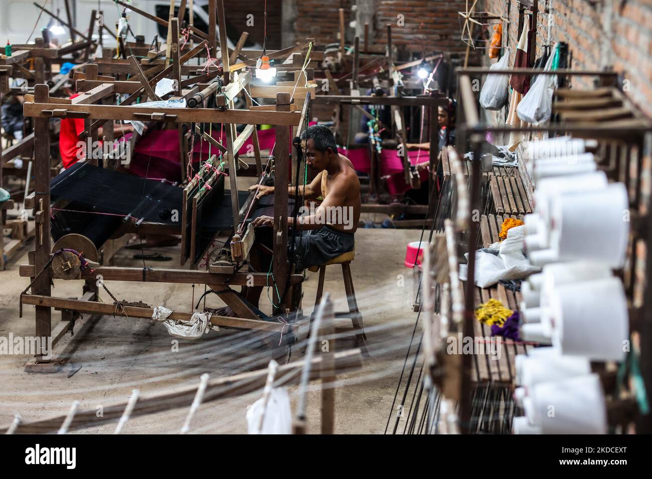 A worker weaver making textiles at the traditional weaving workshop at ...