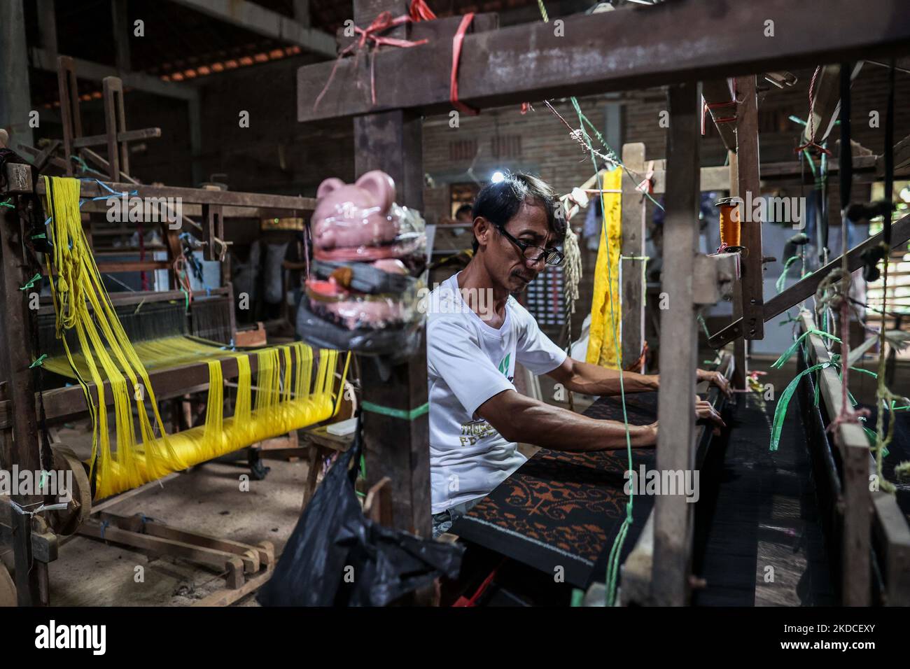 A worker weaver making textiles at the traditional weaving workshop at ...