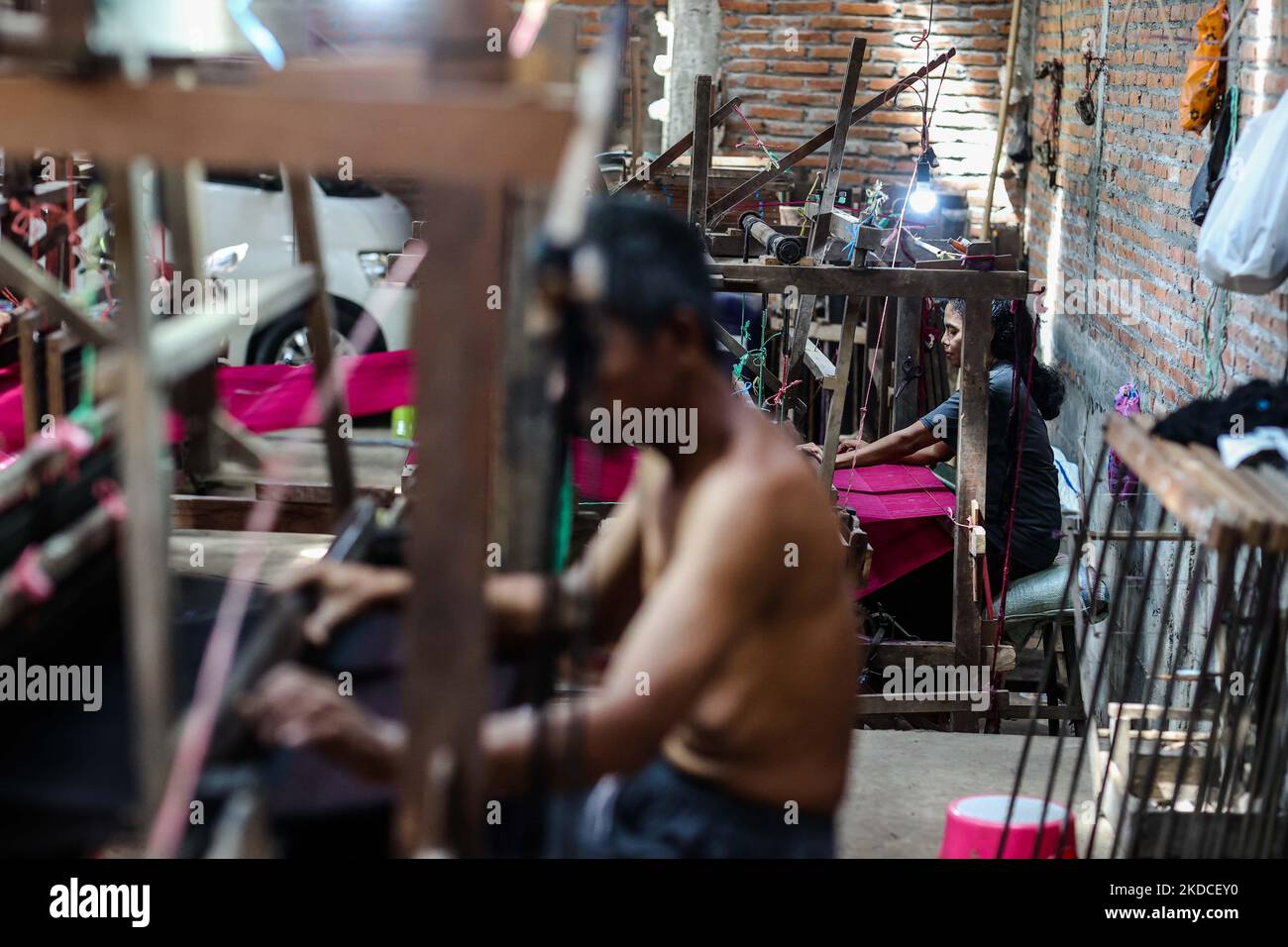 A worker weaver making textiles at the traditional weaving workshop at ...