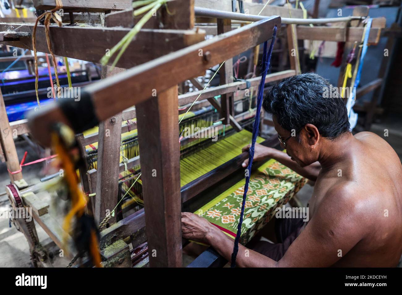 A worker weaver making textiles at the traditional weaving workshop at ...