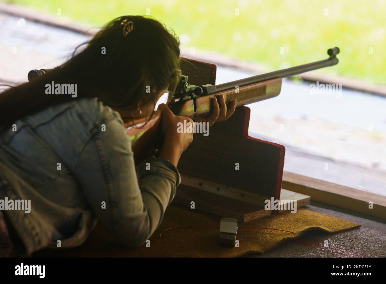 A woman aims a rifle at a shooting range in Krakow, Poland on June 21 ...