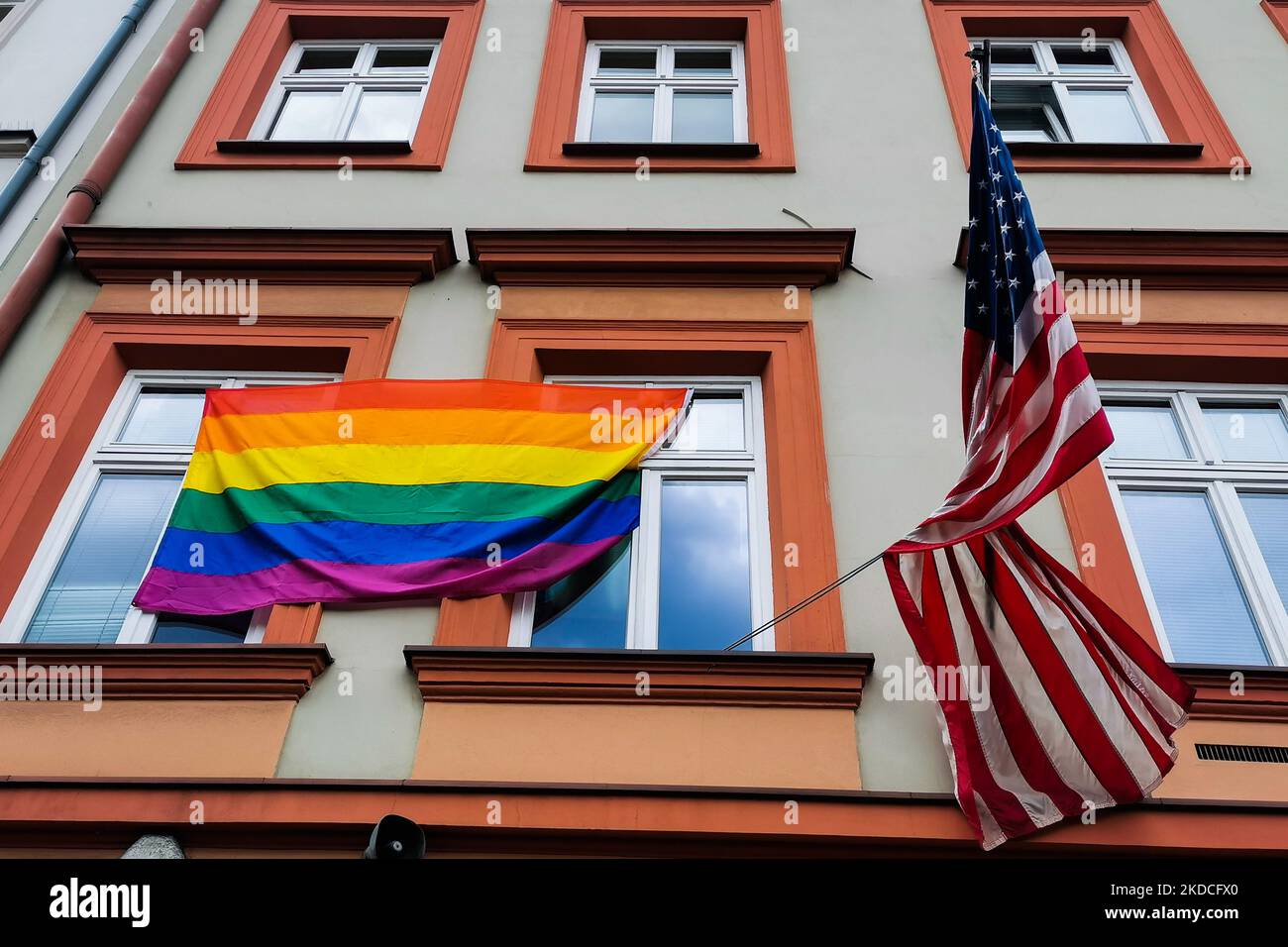LGBT pride flag is hanging next to the US national flag over the ...
