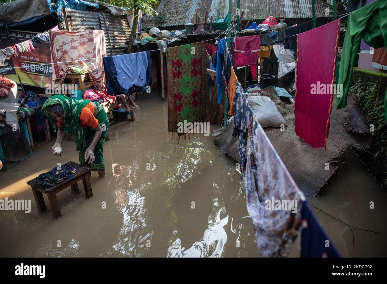 People wash their clothes in a water logged road in companiganj, sylhet ...