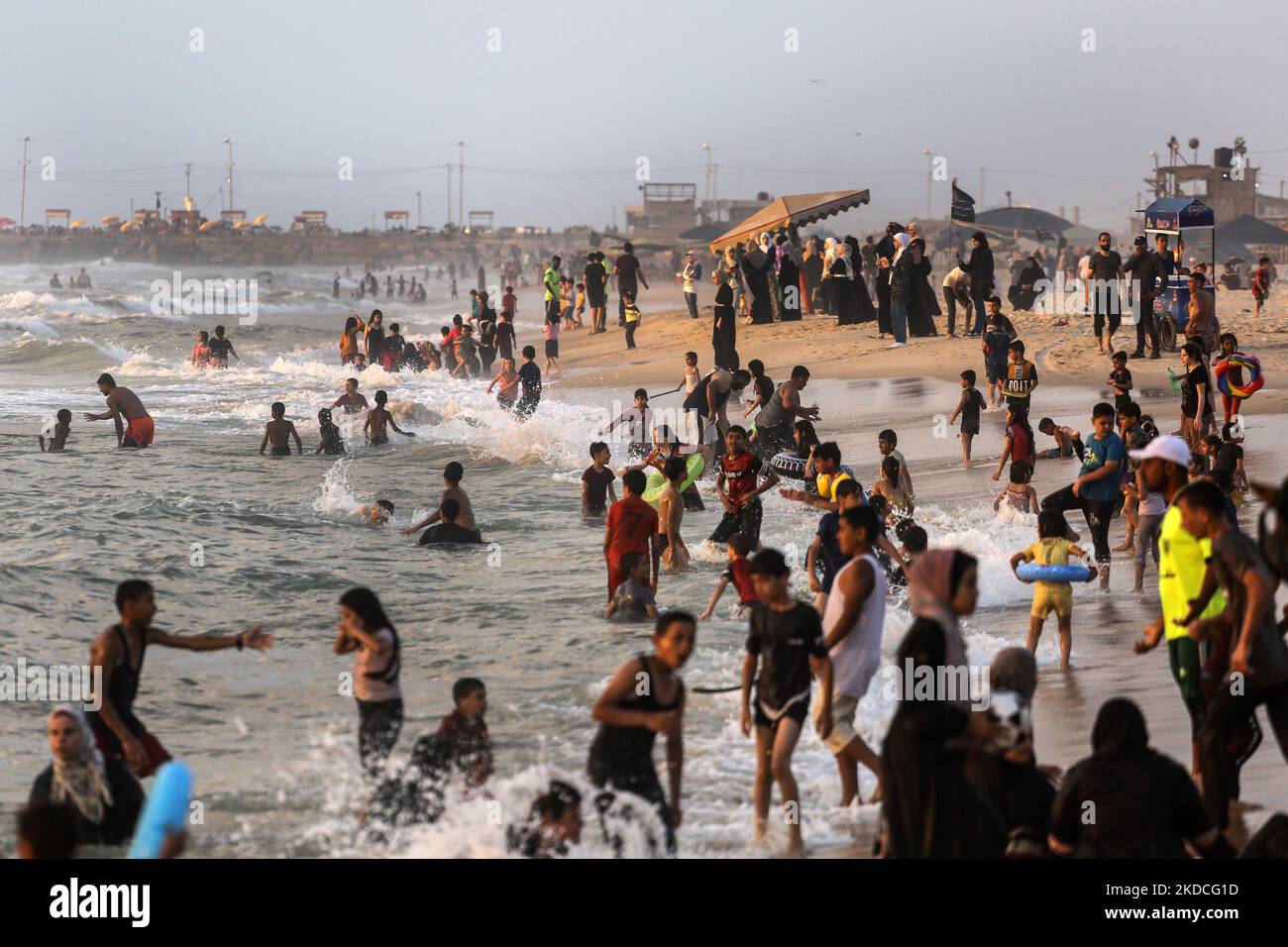 Palestinians swim in Gaza Beach to cool off on a hot day and enjoy ...