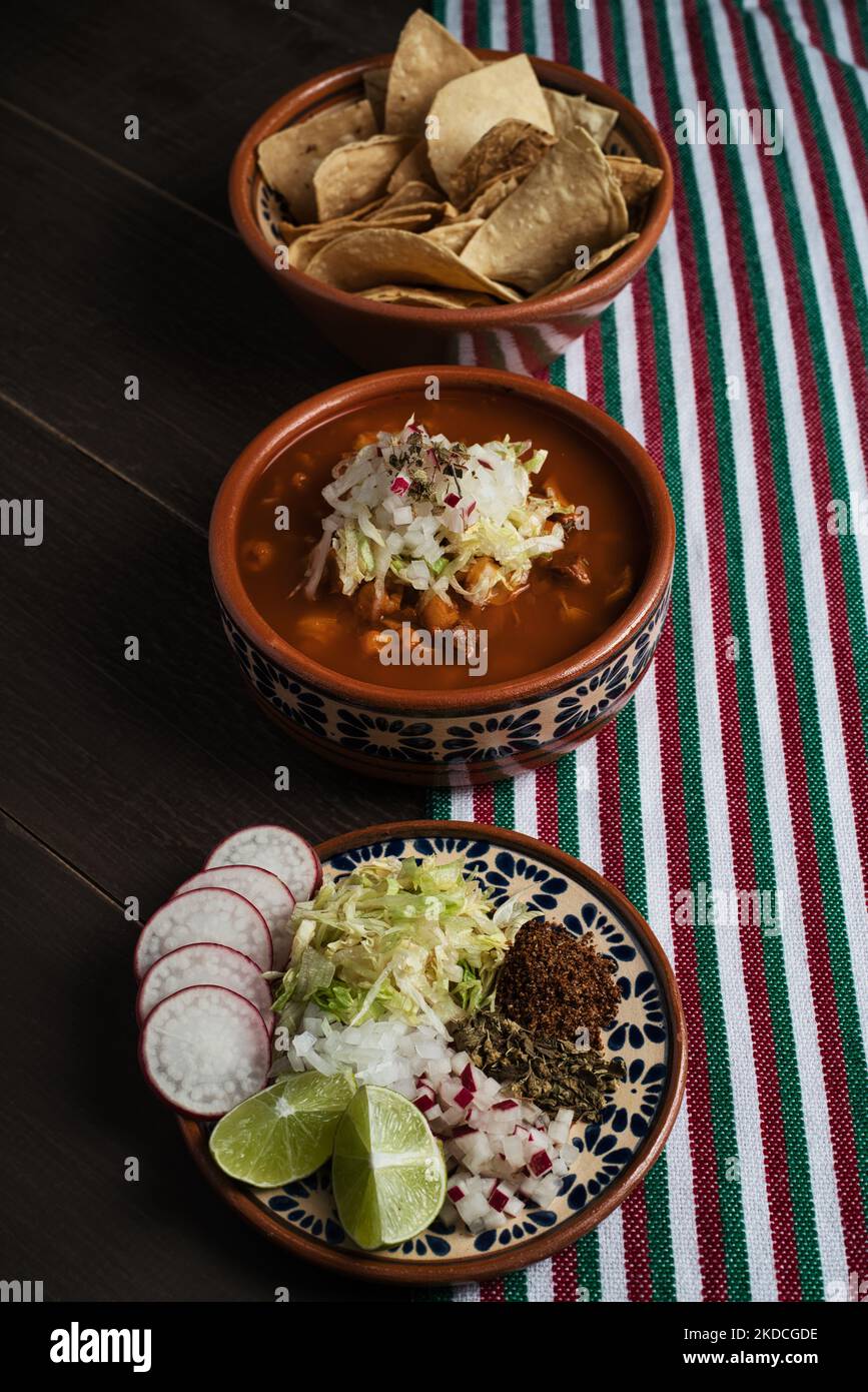 A vertical shot of Pozole Rojo (Mexican Pork and Hominy Stew),tortilla ...