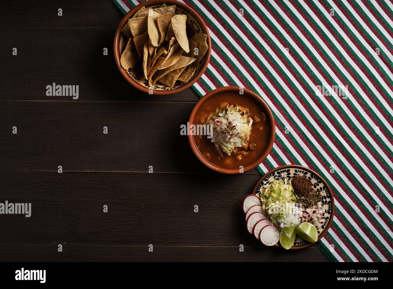 A top view of Pozole Rojo (Mexican Pork and Hominy Stew),tortilla chips ...