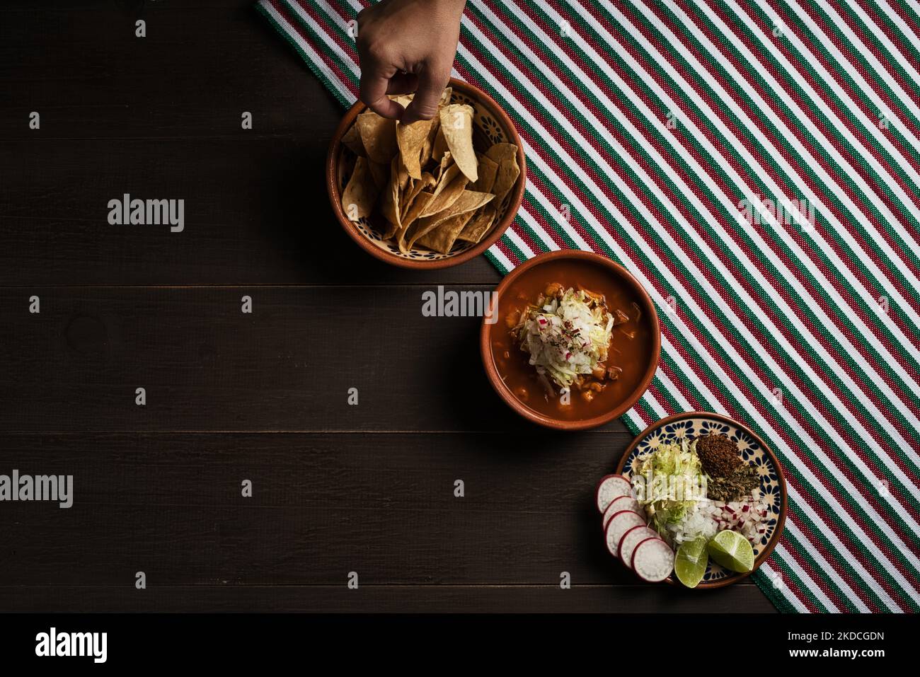 A top view of Pozole Rojo (Mexican Pork and Hominy Stew),tortilla chips ...