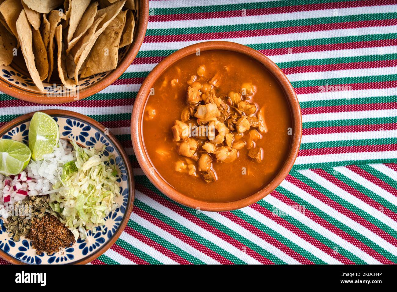 A top view of Pozole Rojo (Mexican Pork and Hominy Stew),tortilla chips ...