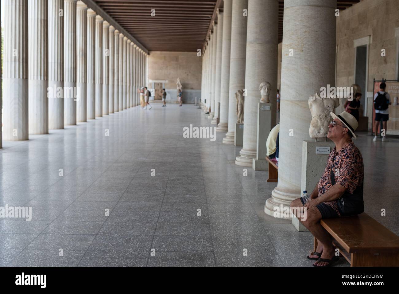 A tourist rests at the Stoa of Attalus during a heatwave in Athens ...