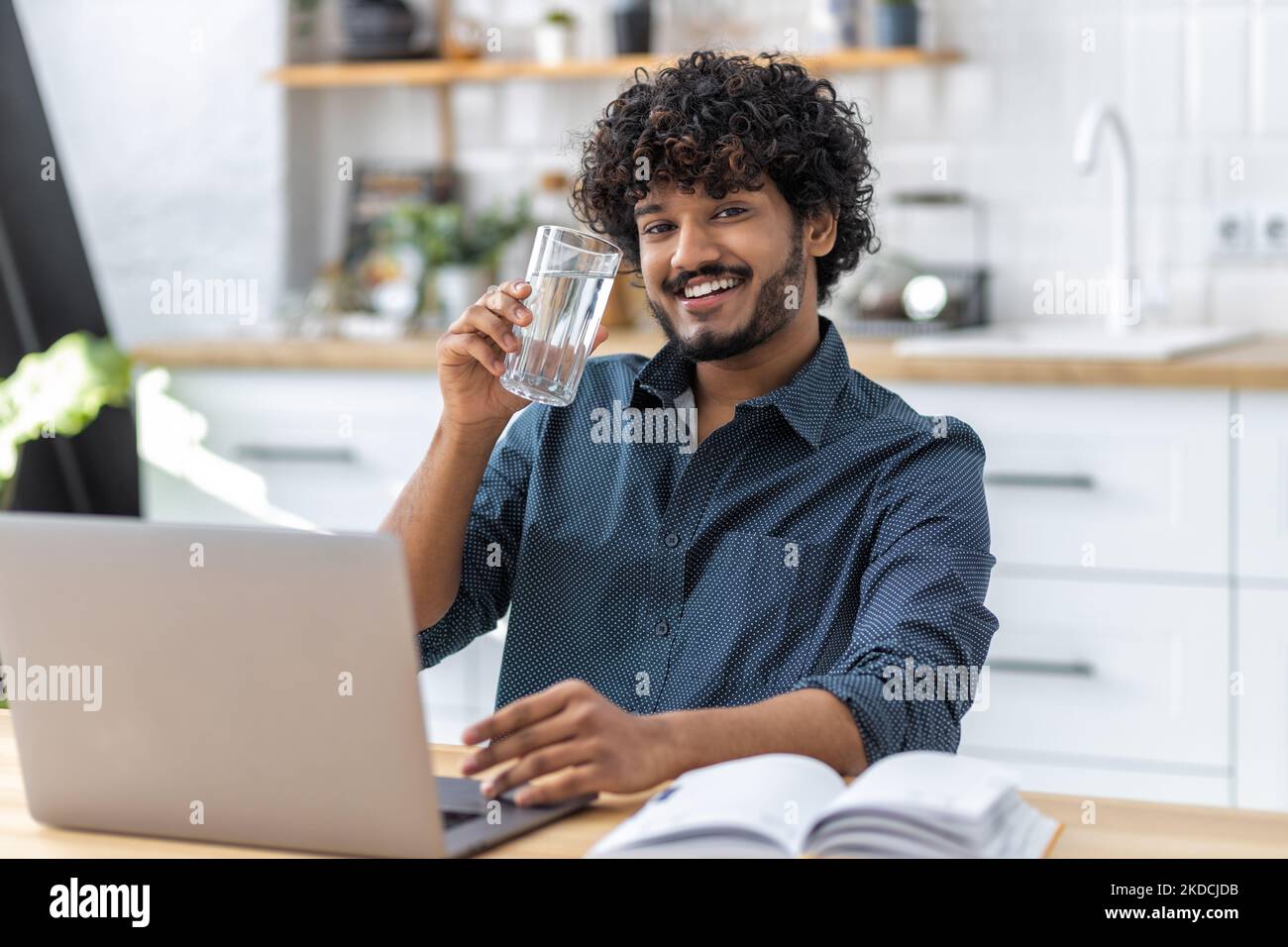 Happy successful young Asian man entrepreneur or freelancer holding ...