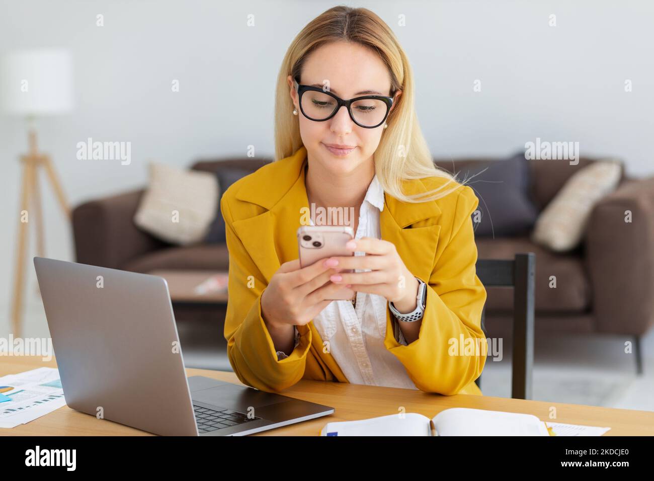 Beautiful woman working using computer laptop and mobile phone, concentrated sitting in modern ...