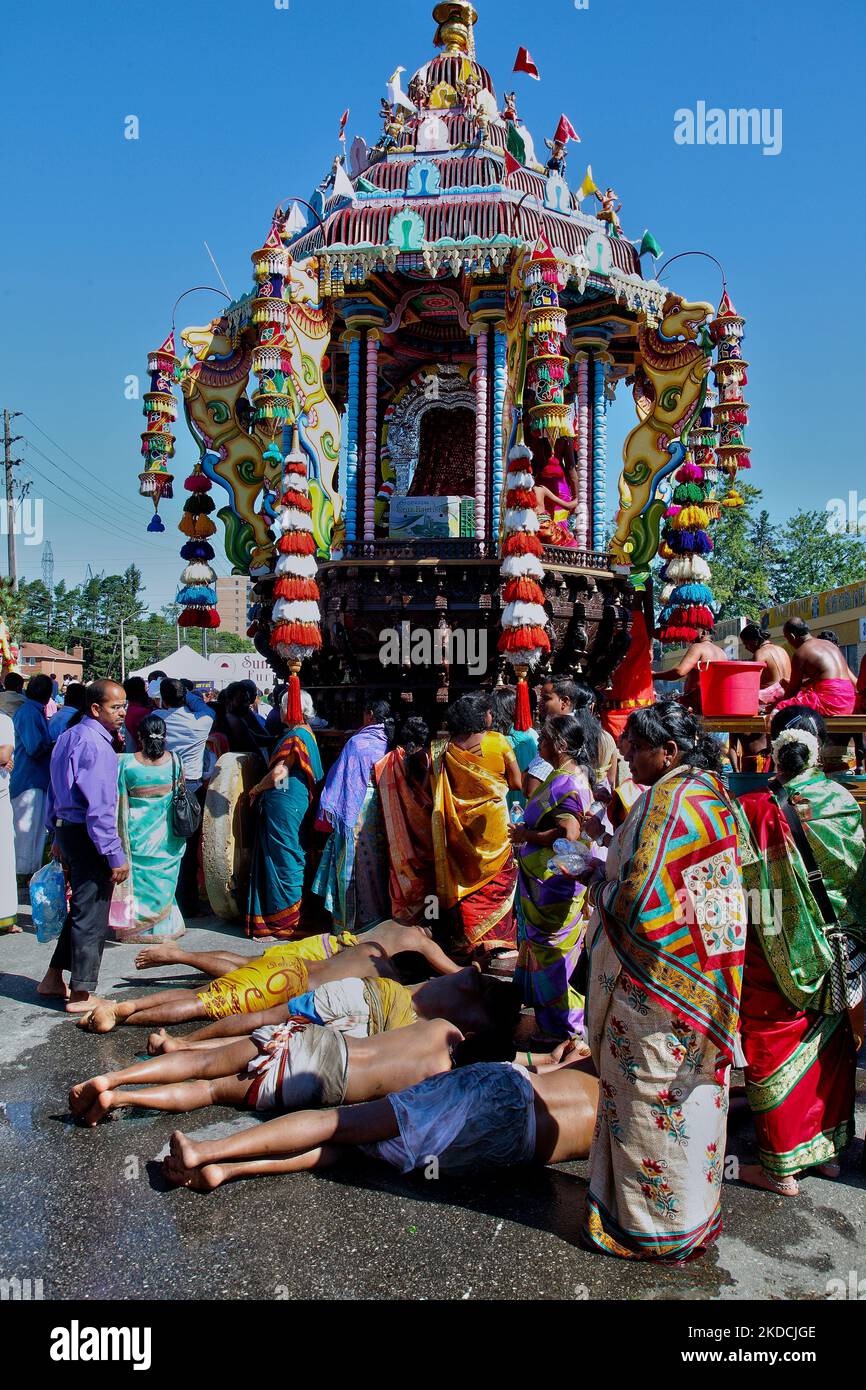 Tamil Hindu devotees perform the Angapradakshinam ritual (as an act of ...