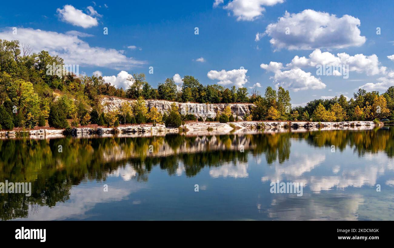 Landscape with lake reflecting cloudy sky and rock bluffs at Klondike ...