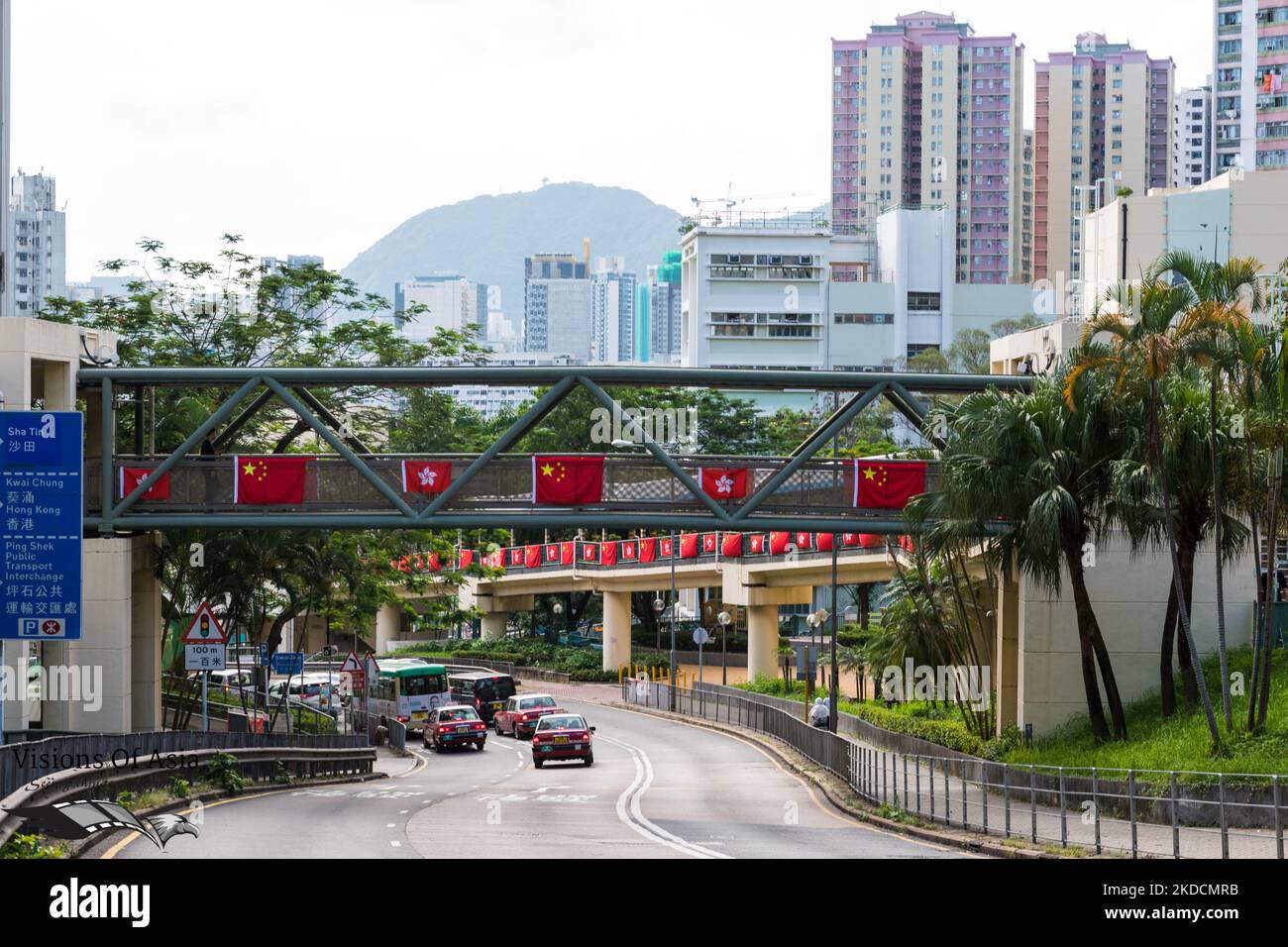 Chinese and Hong Kong flags are affixed to a walkway above New ...