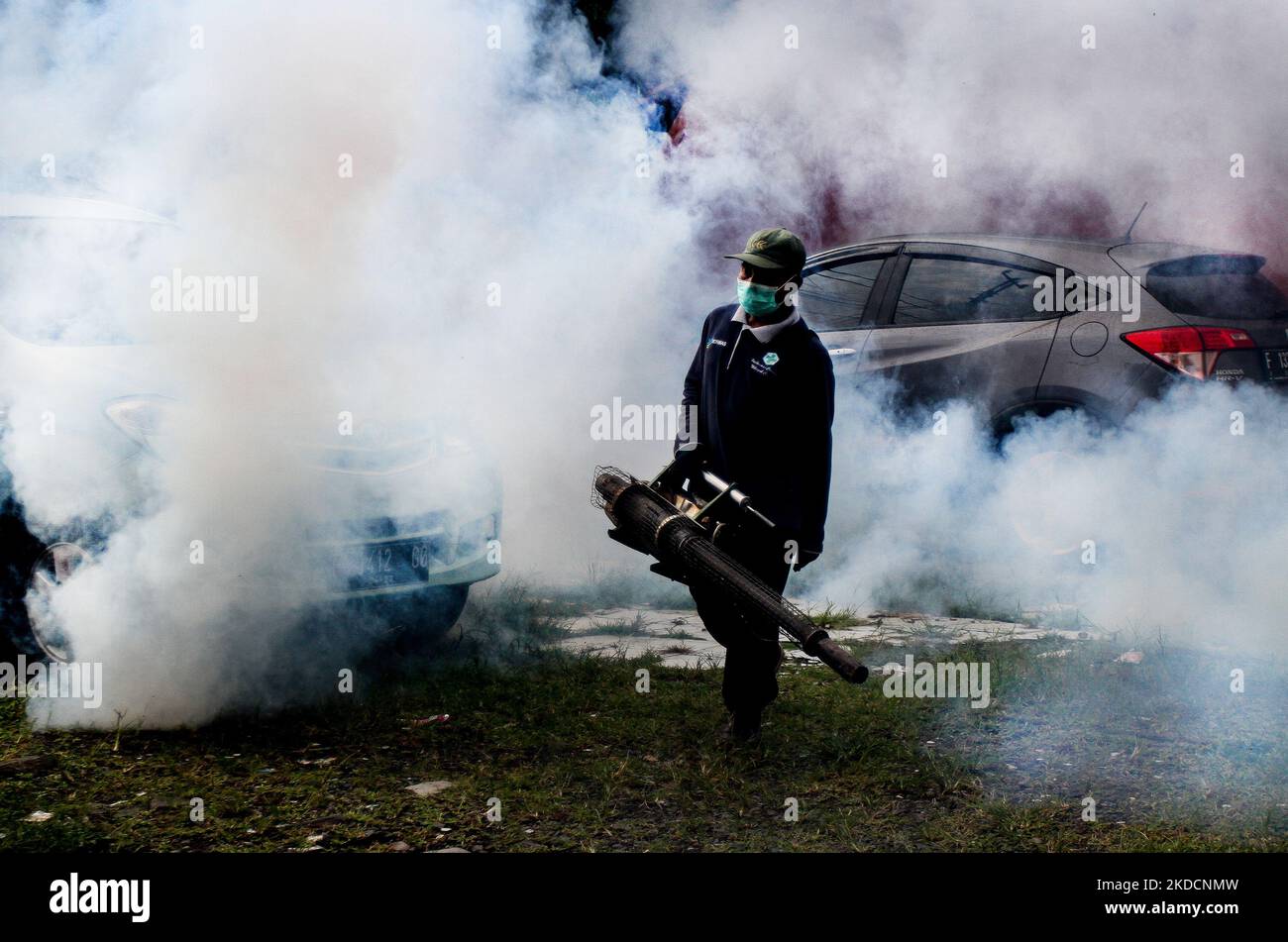 A health worker fumigates to kill mosquito larvae to fight against the ...