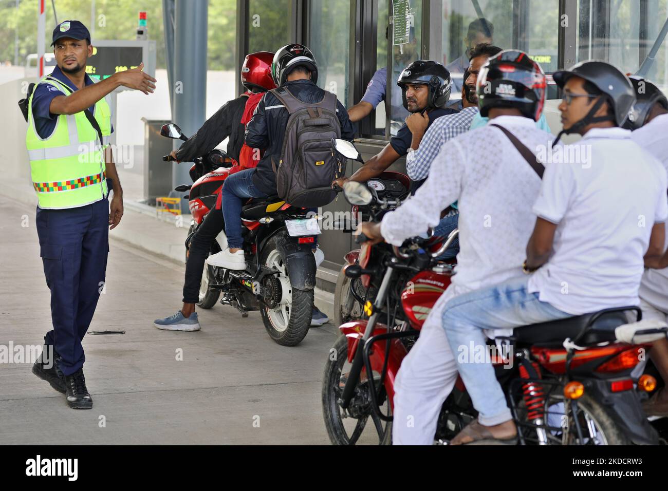 People on motorcycles queue to pay the toll for the newly built Padma ...