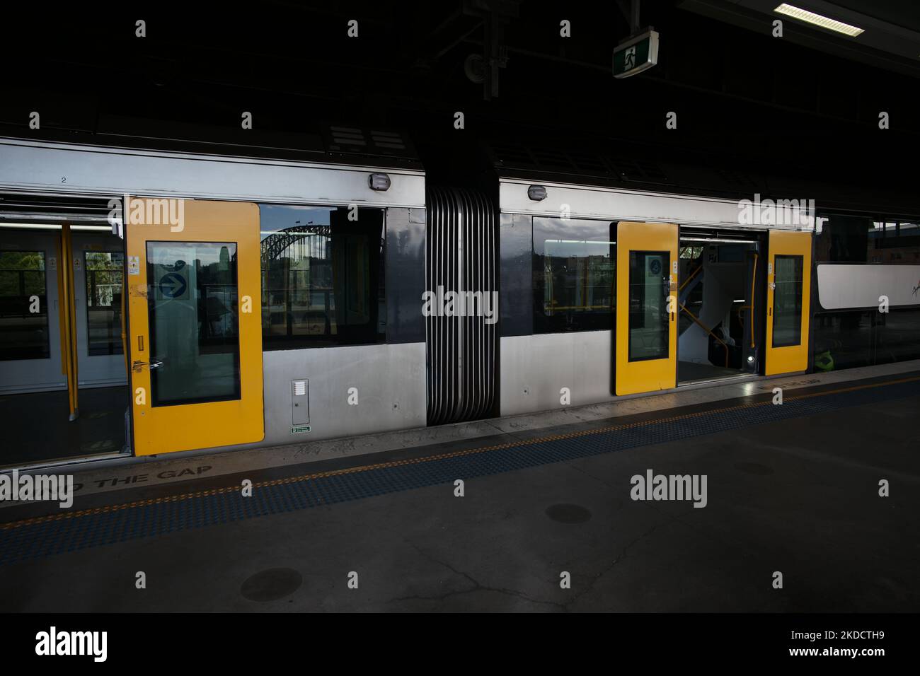 A modern subway car with yellow doors arrives at a station Stock Photo ...