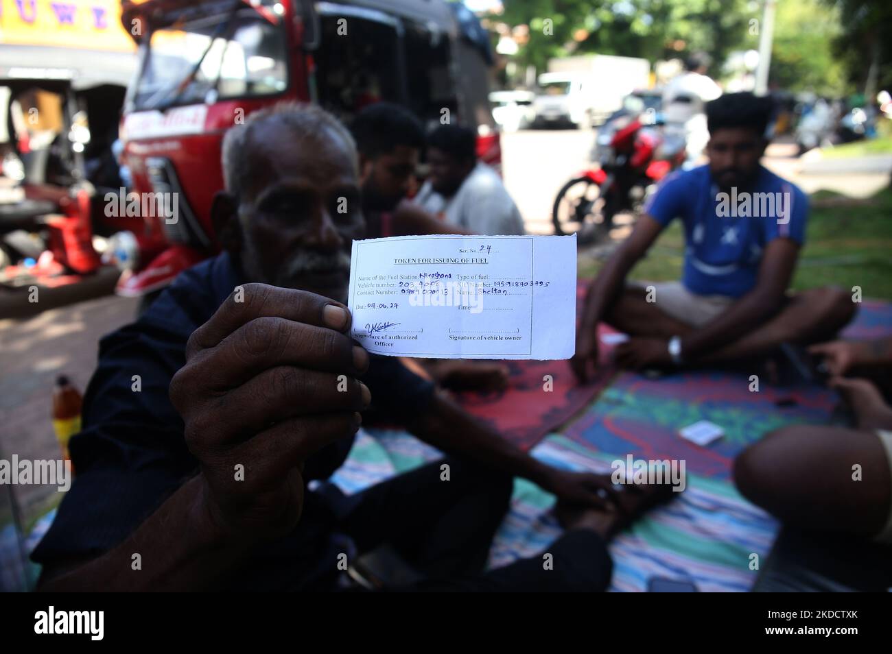 A man shows a fuel token as the Sri Lanka army issued fuel tokens to ...