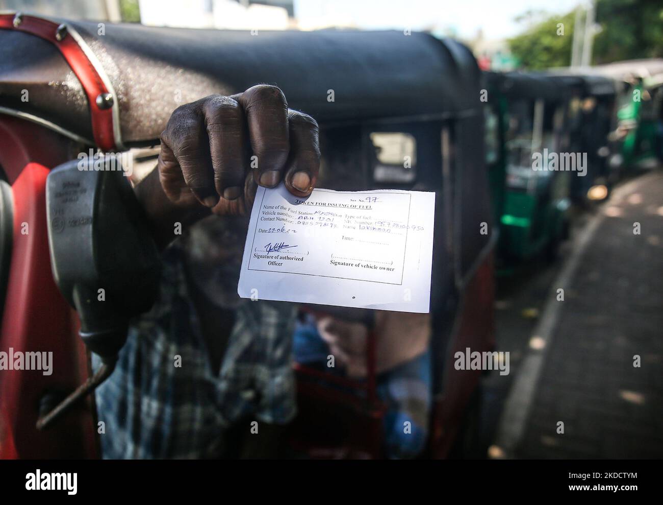 A man shows a fuel token as the Sri Lanka army issued fuel tokens to ...