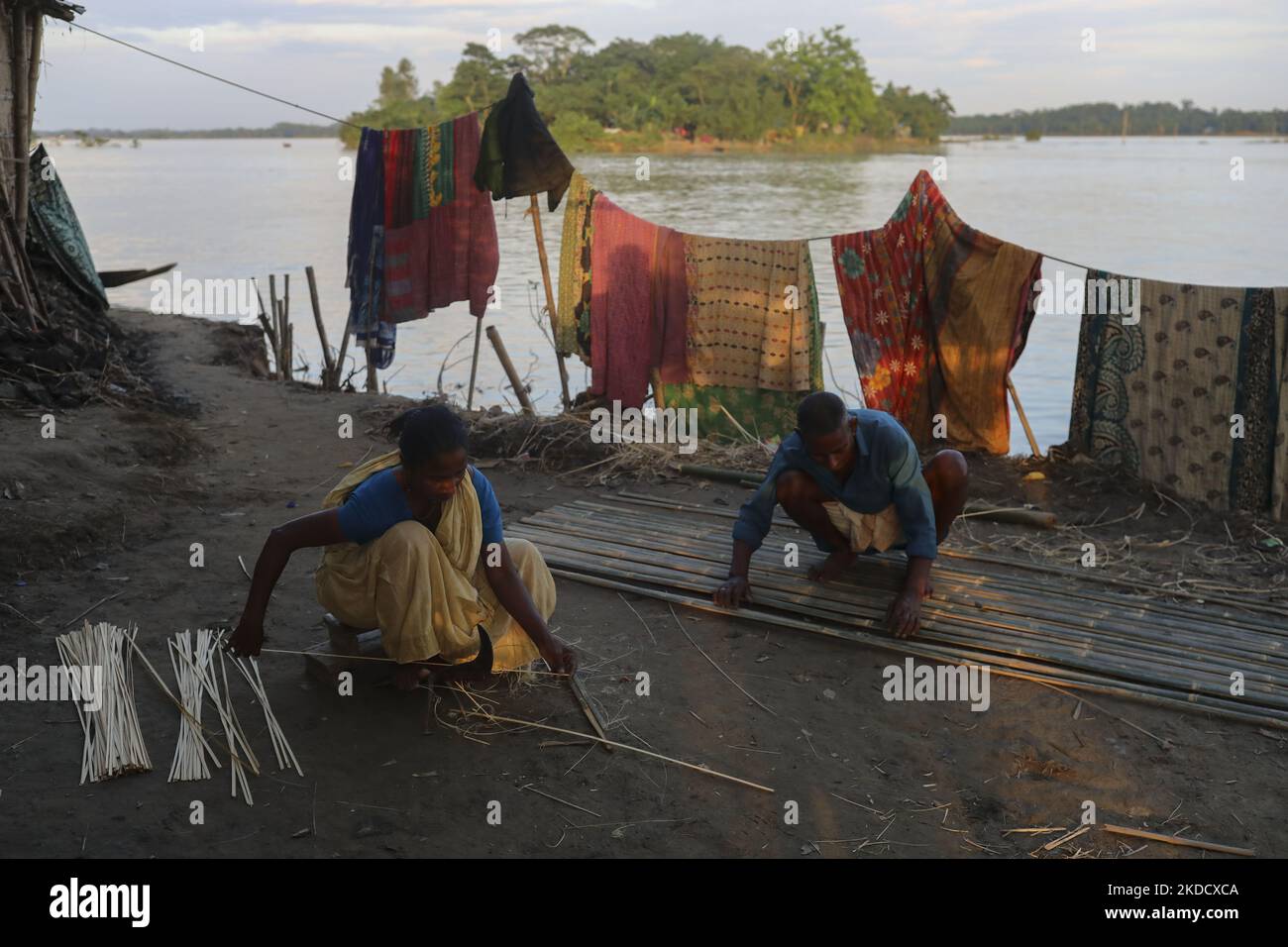 Flood affected people back to their house and try to fixes their house ...