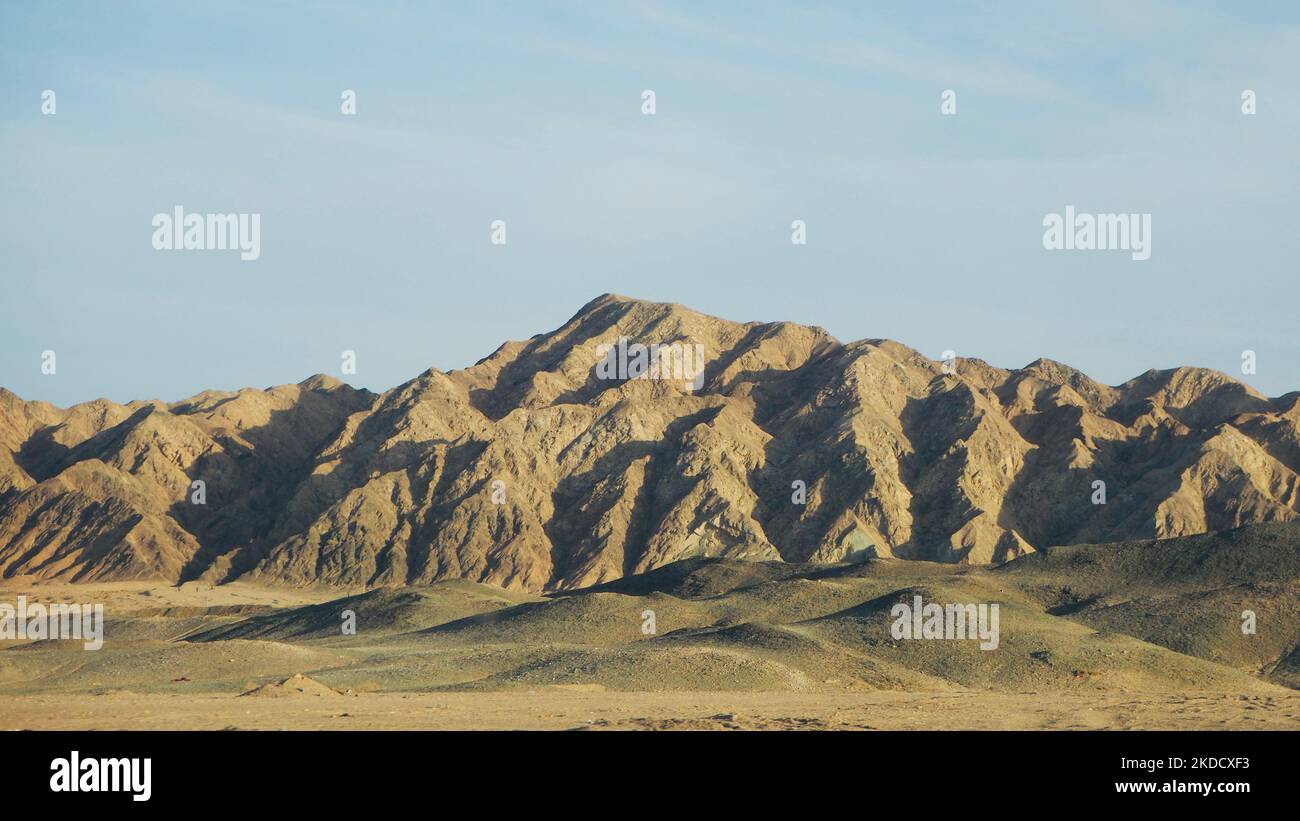 A low-angle of sunlit hills in the horizon, clear sky background Stock ...