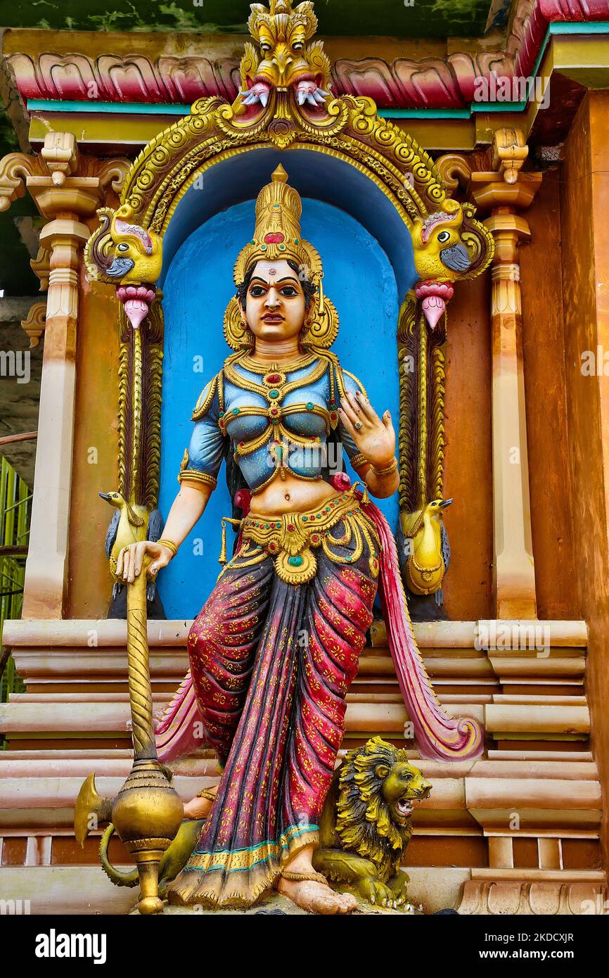 Statue of a female guardian deity atop a lion at the entrance of the at ...